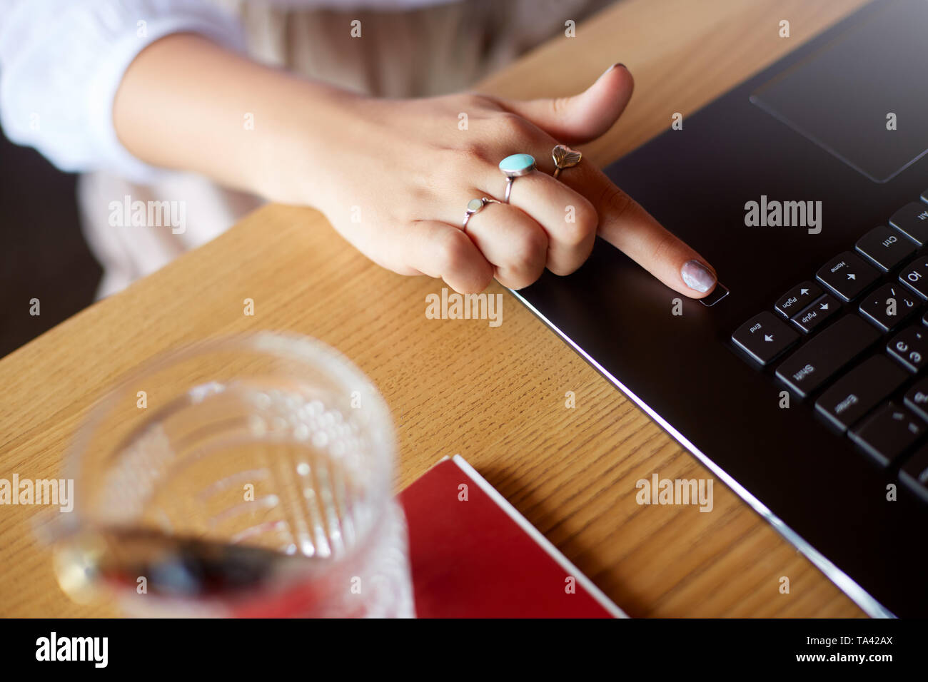 Close up photo of woman touching laptop fingerprint sensor with her ...