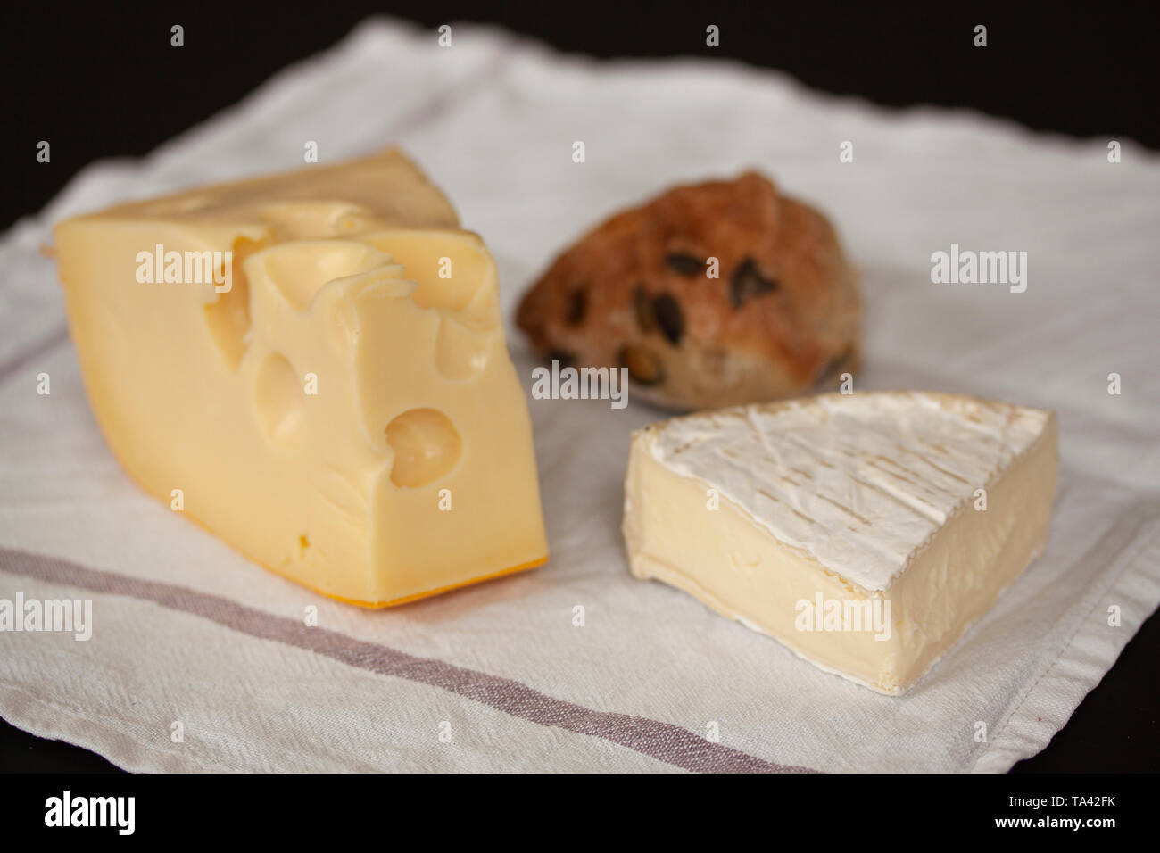 French brie and Swiss Emmental cheese with slices of salami sausage and ...