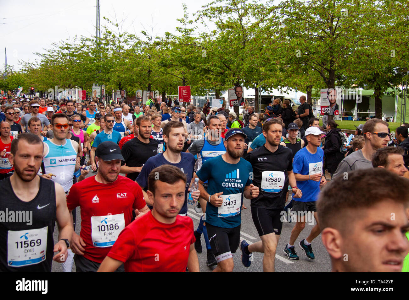 Group of marathon runners men and women running on city street Stock ...