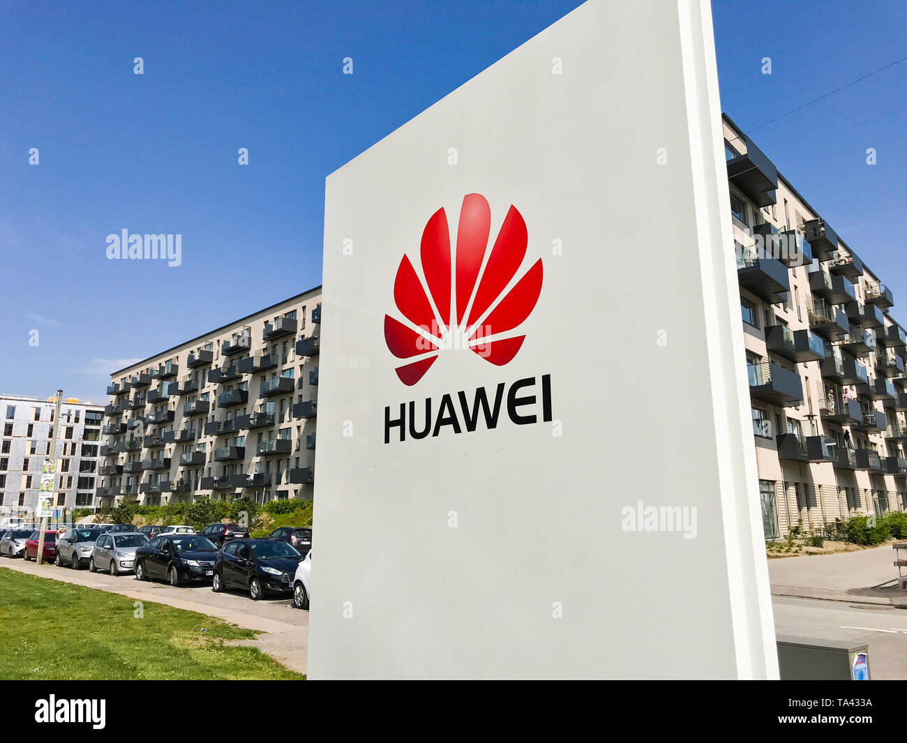 Huawei logotype on white panel sign with clear blue sky and modern ...