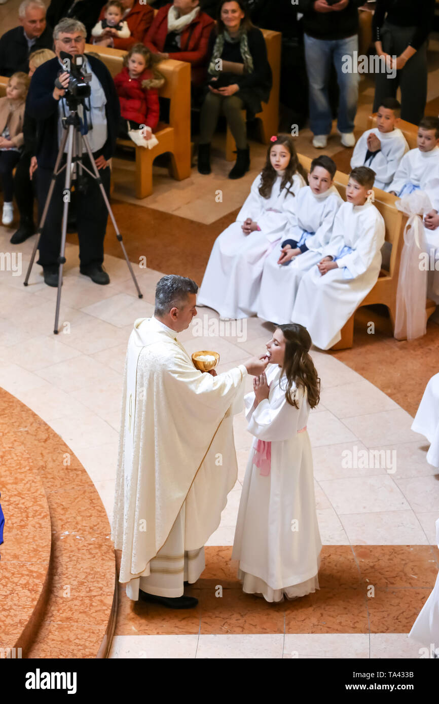 Zagreb, Croatia - May 5, 2019 : The priest gives first communion to the ...