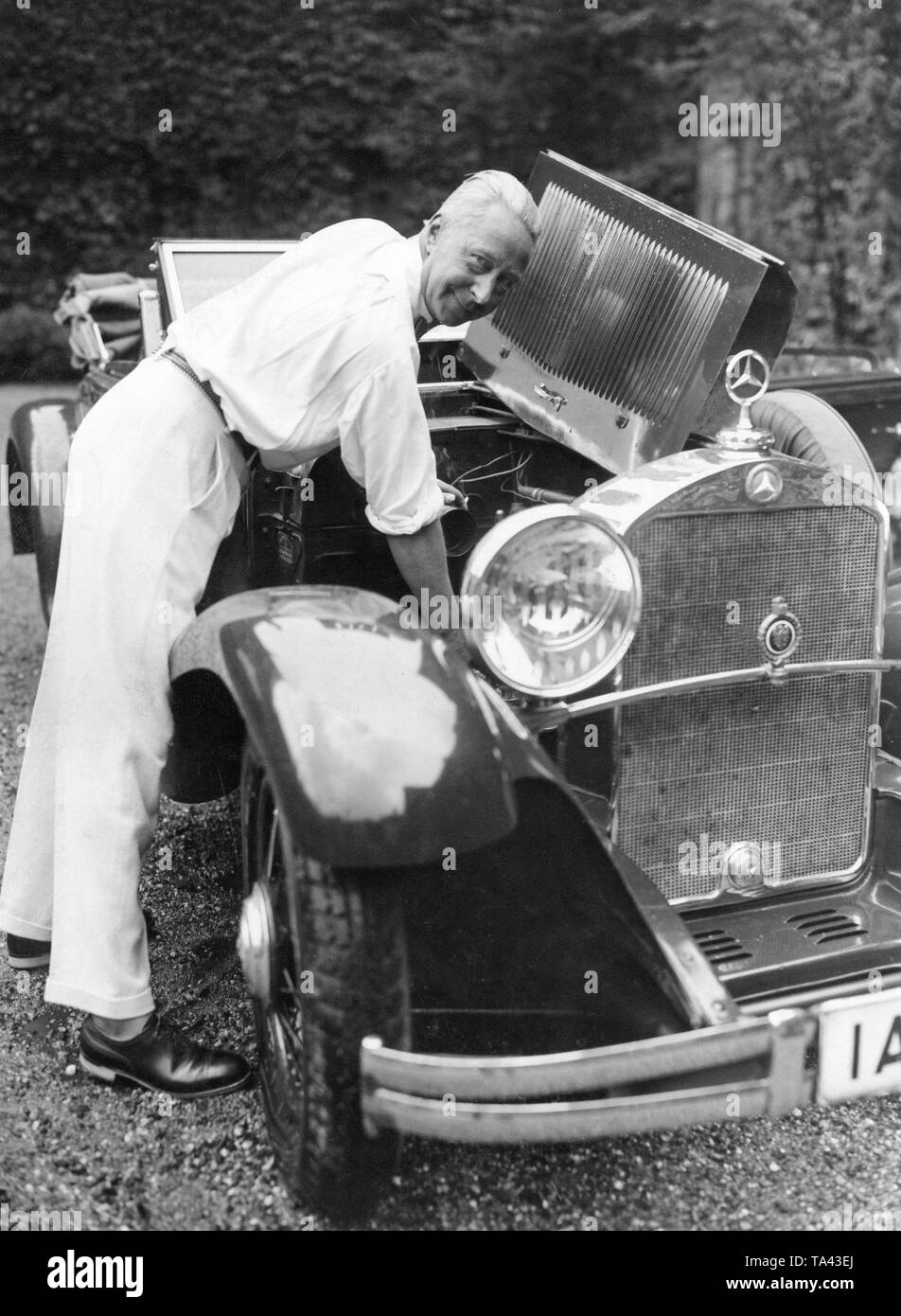 Crown Prince Wilhelm with his Mercedes car. He has opened the engine ...