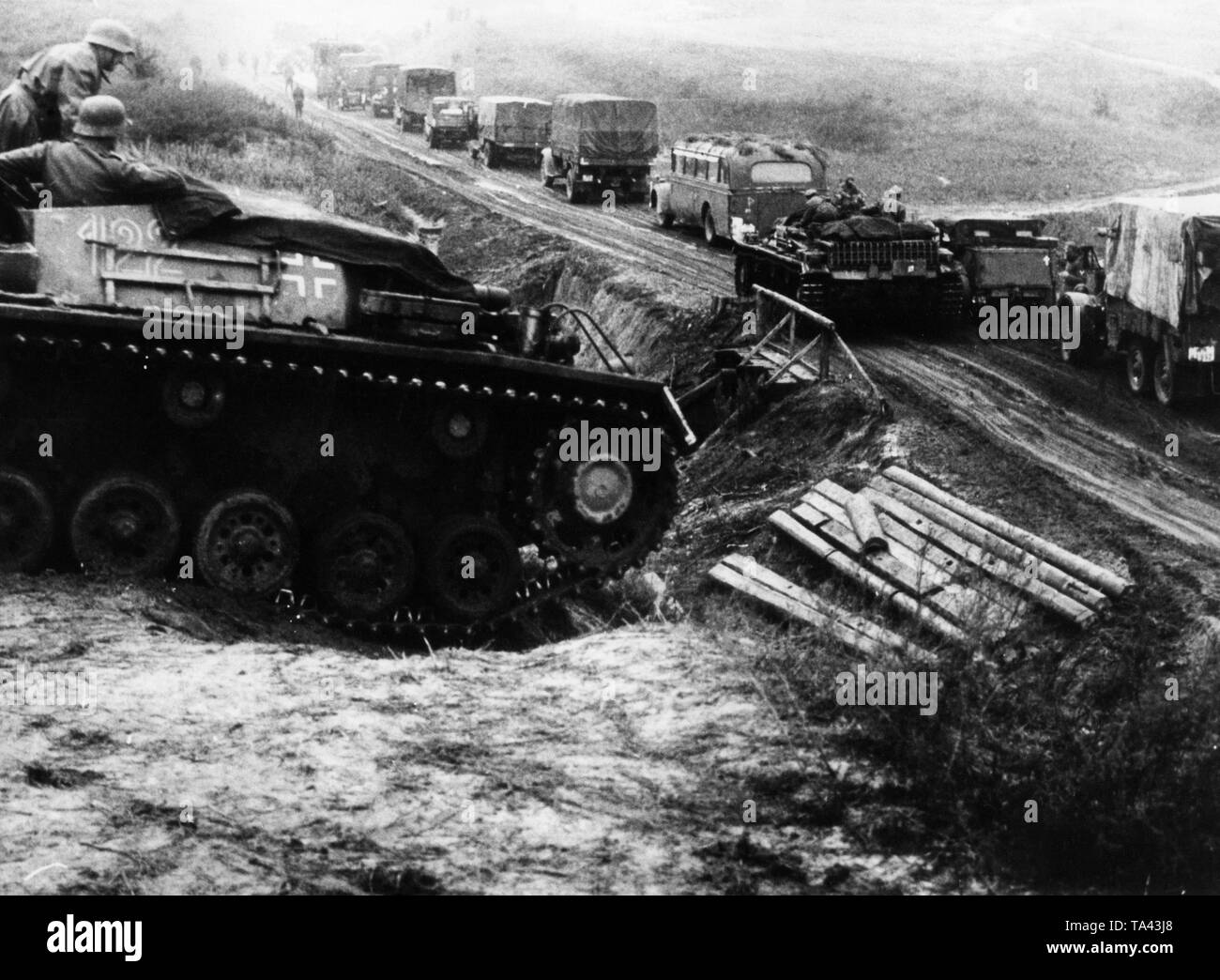 A vehicle column of the Wehrmacht on the advance. Two Sturmgeschuetz ...