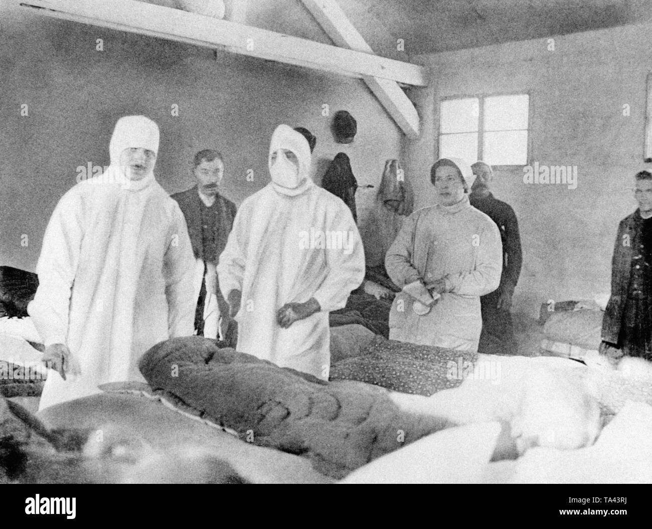 Doctors in overalls during the treatment of patients suffering from ...