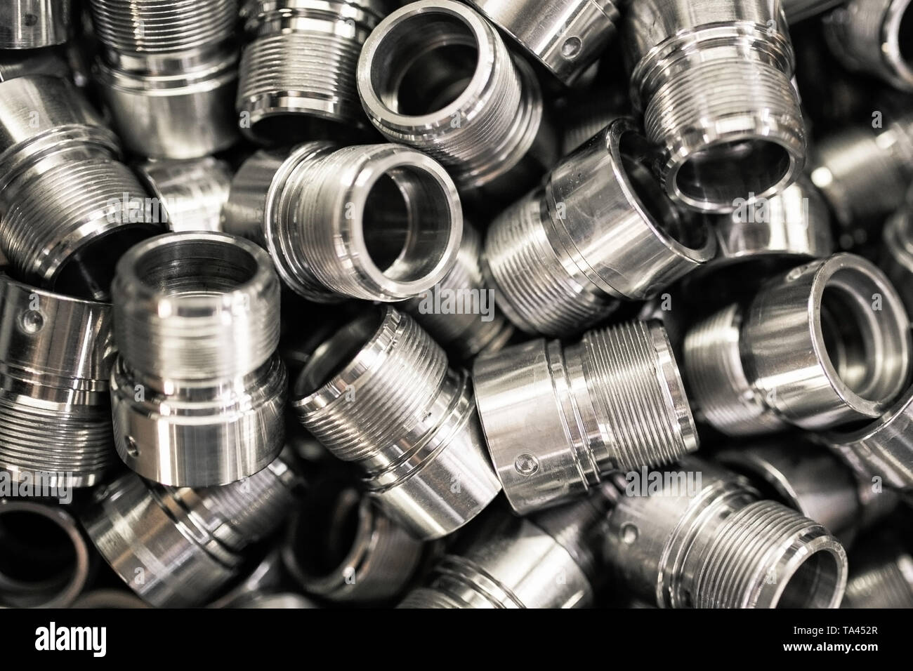 Pile of many CNC turning engineering parts. Metal parts, metal blanks ...