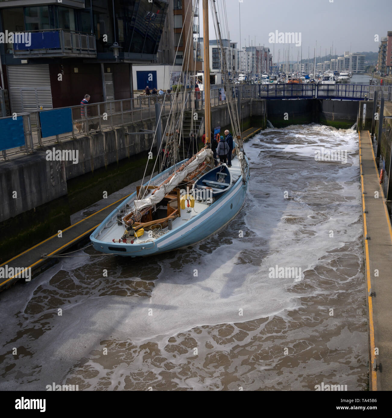 A replica Pilot Cutter from the Bristol Channel enters a Marina lock ...