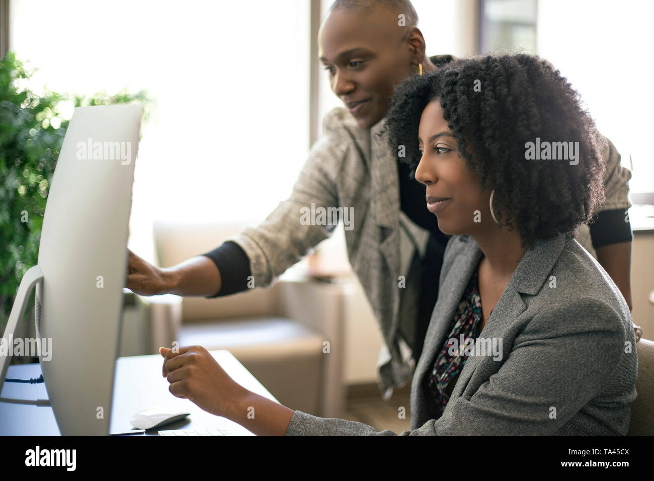 Black African American businesswomen or coworkers together in an office ...