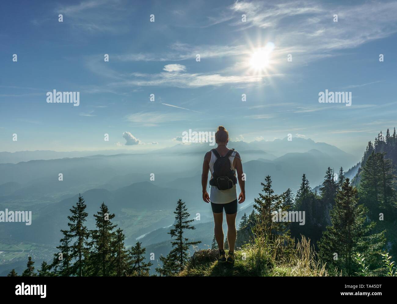 A strong muscular female hiker standing on the edge of the hill Stock ...