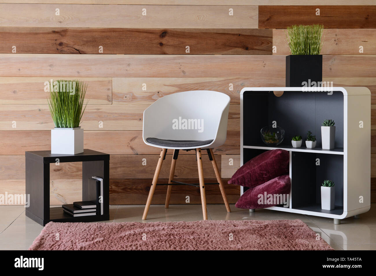 Interior of modern room with chair near wooden wall Stock Photo - Alamy