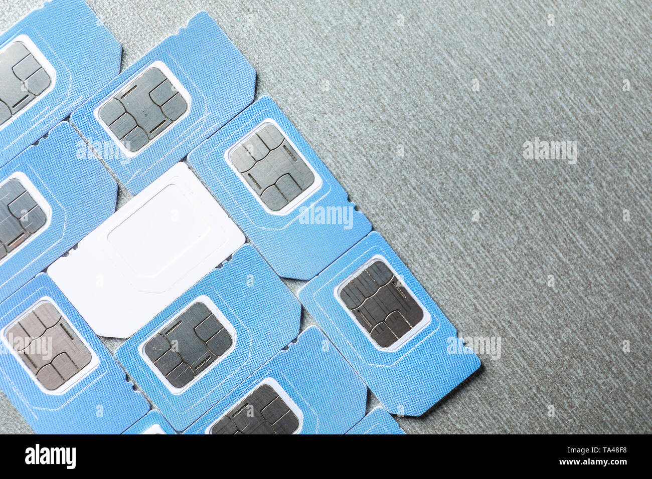 Many sim cards on grey background Stock Photo - Alamy