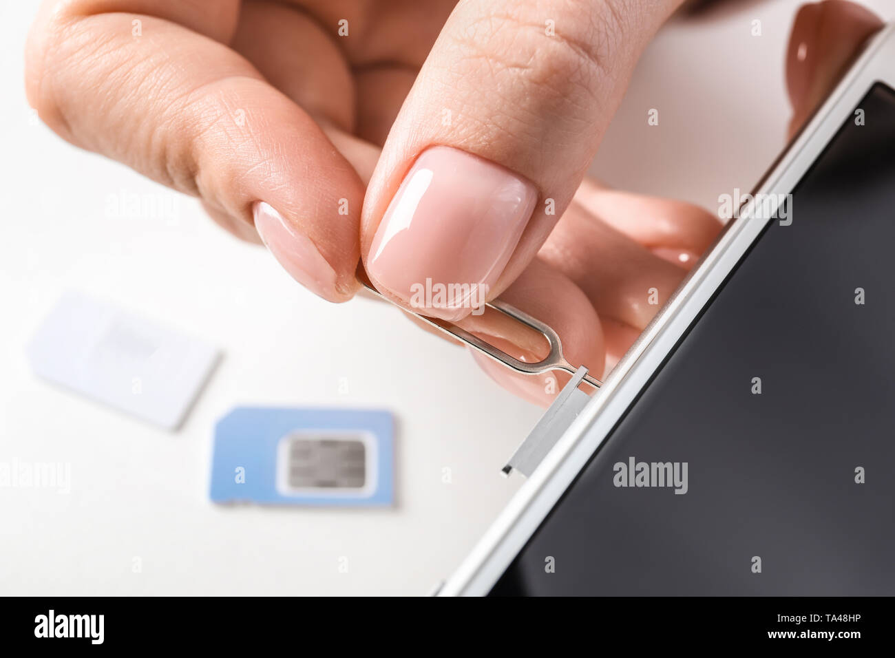 Woman holding sim card hi-res stock photography and images - Alamy