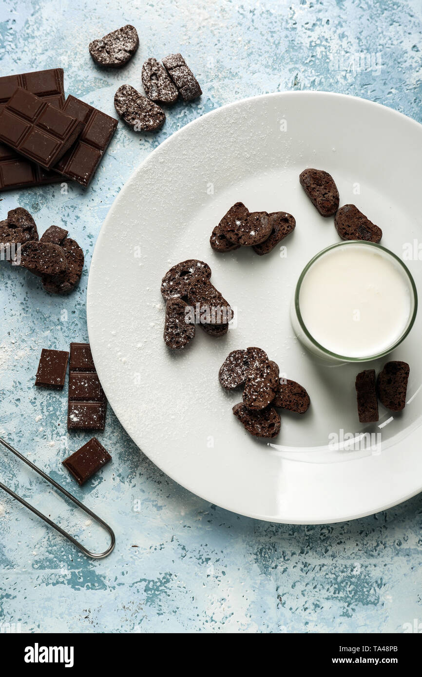 Glass of milk with tasty Italian biscotti on color table Stock Photo ...