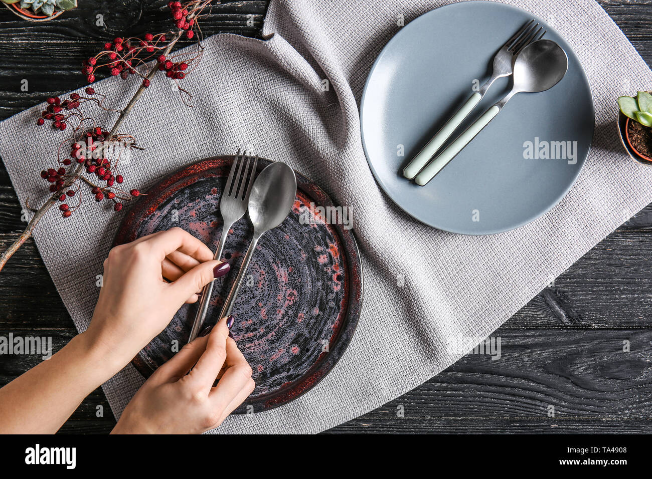 Woman setting a table for dinner Stock Photo - Alamy