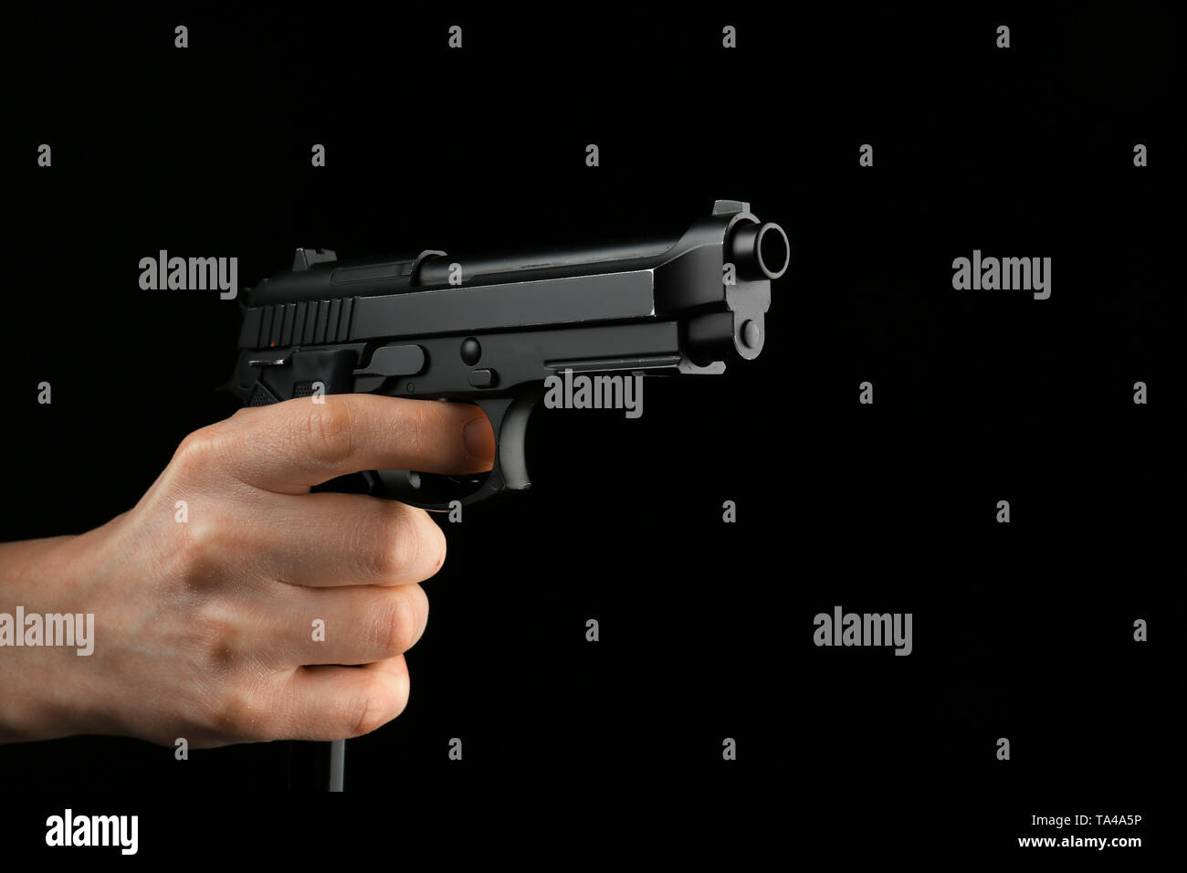 Male hand with pistol on dark background Stock Photo - Alamy