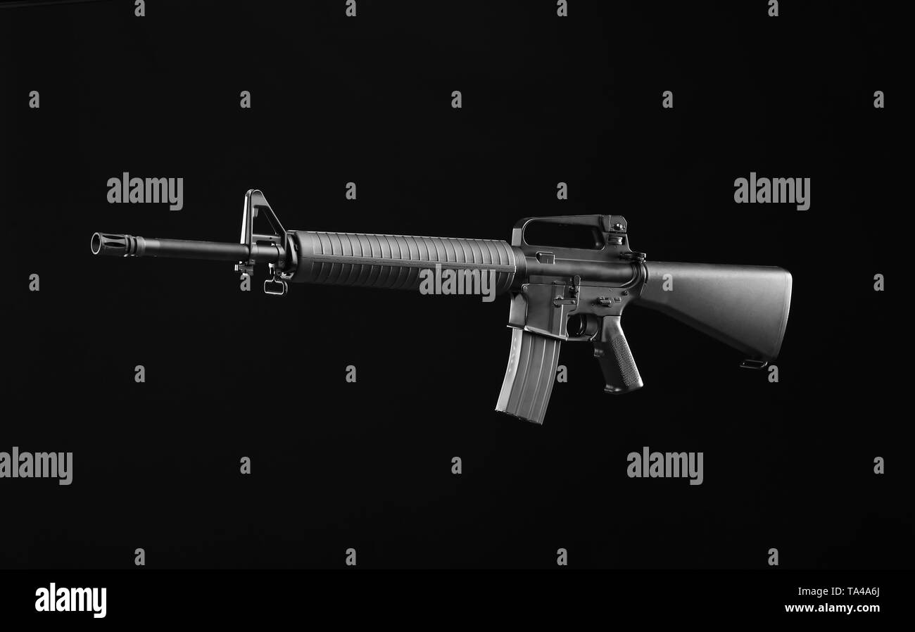 Assault rifle on dark background Stock Photo - Alamy