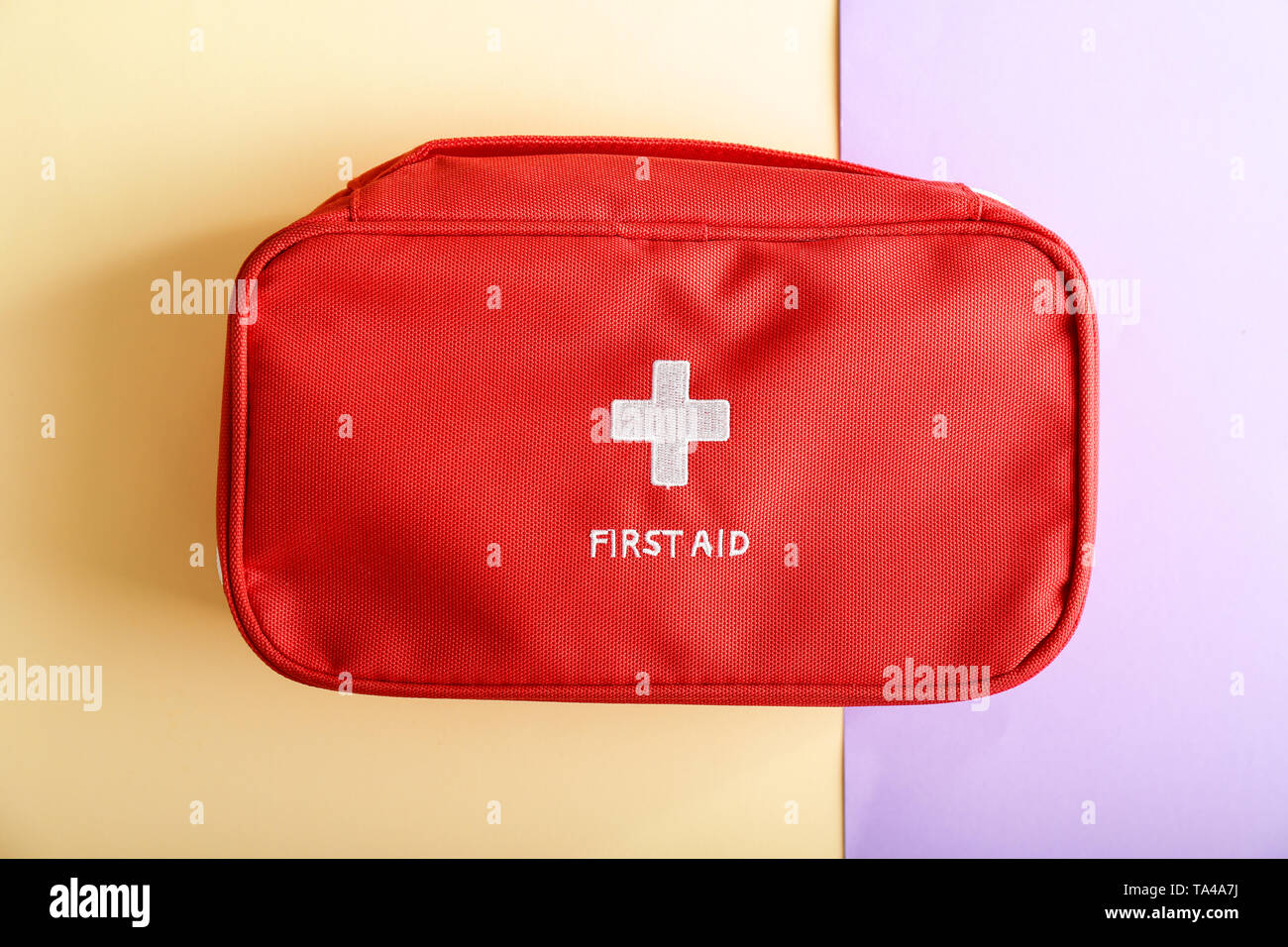First aid kit on color background Stock Photo - Alamy