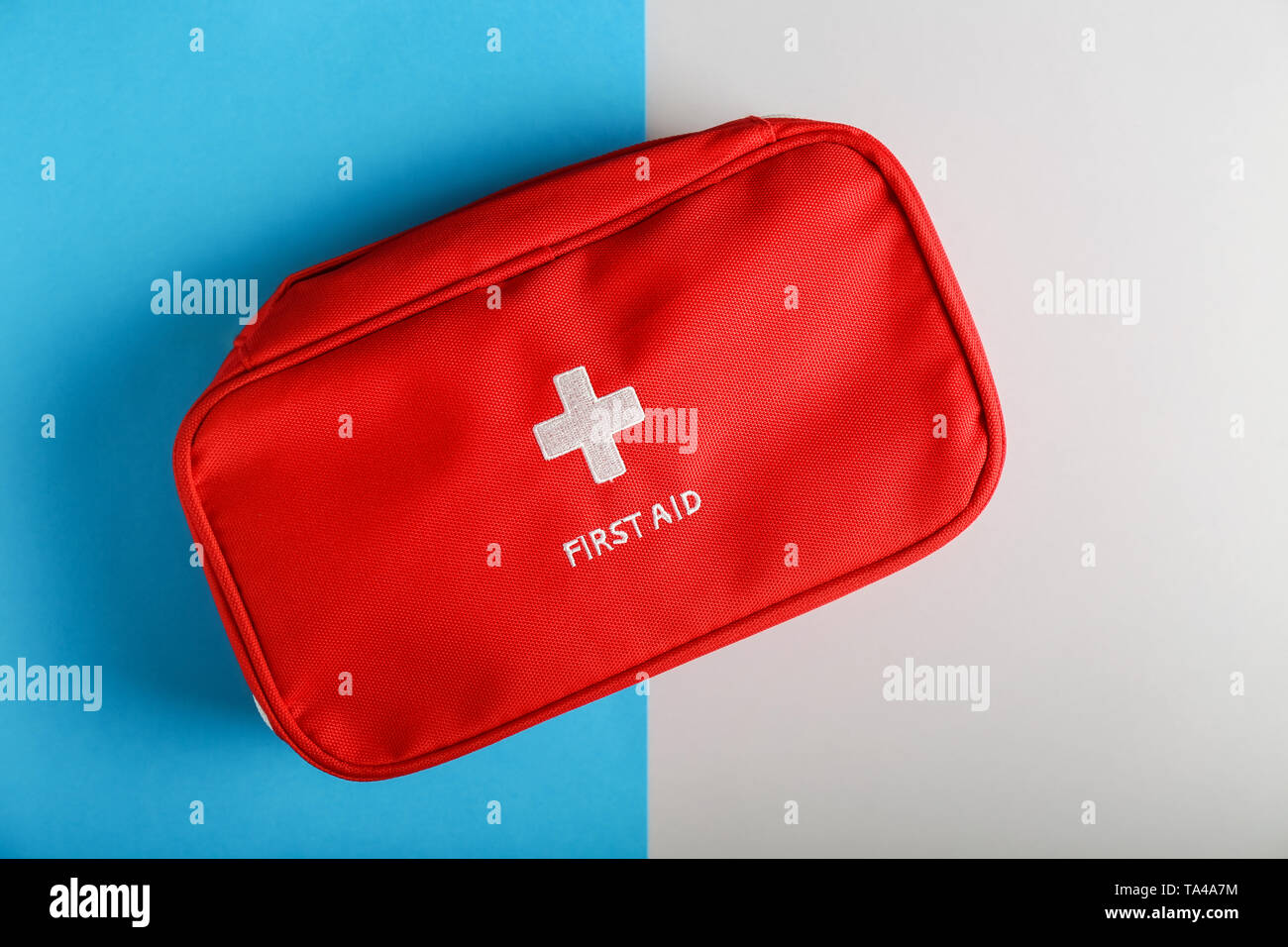 First aid kit on color background Stock Photo - Alamy