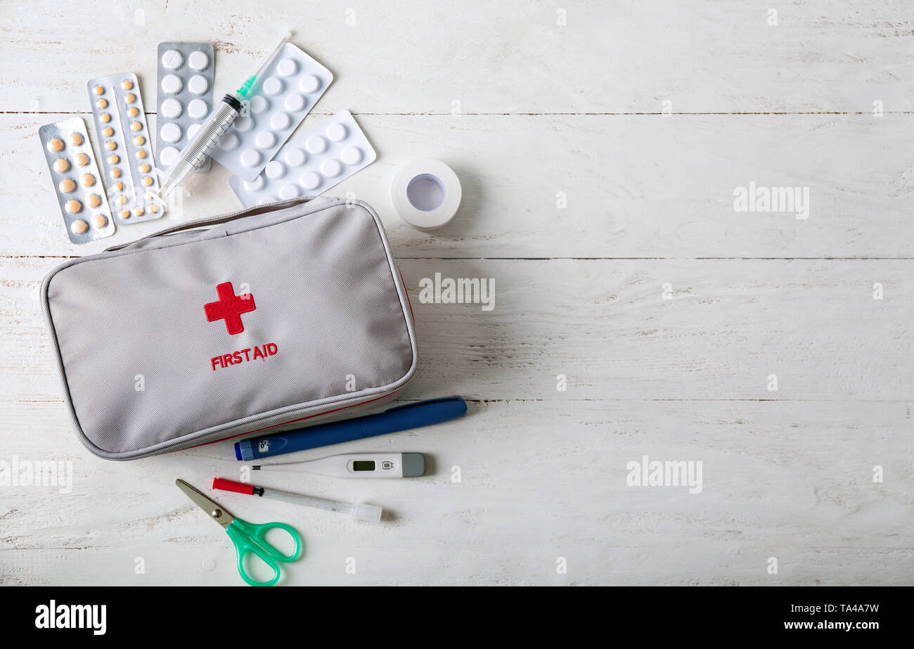 First aid kit on white table Stock Photo - Alamy