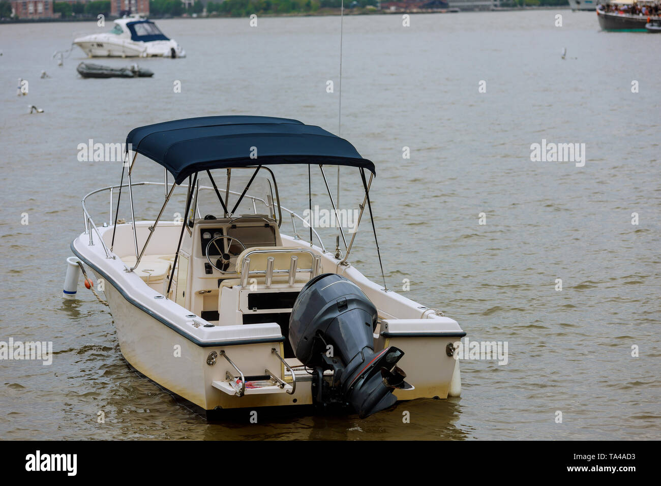 Empty white motor boat floats on the river Stock Photo - Alamy