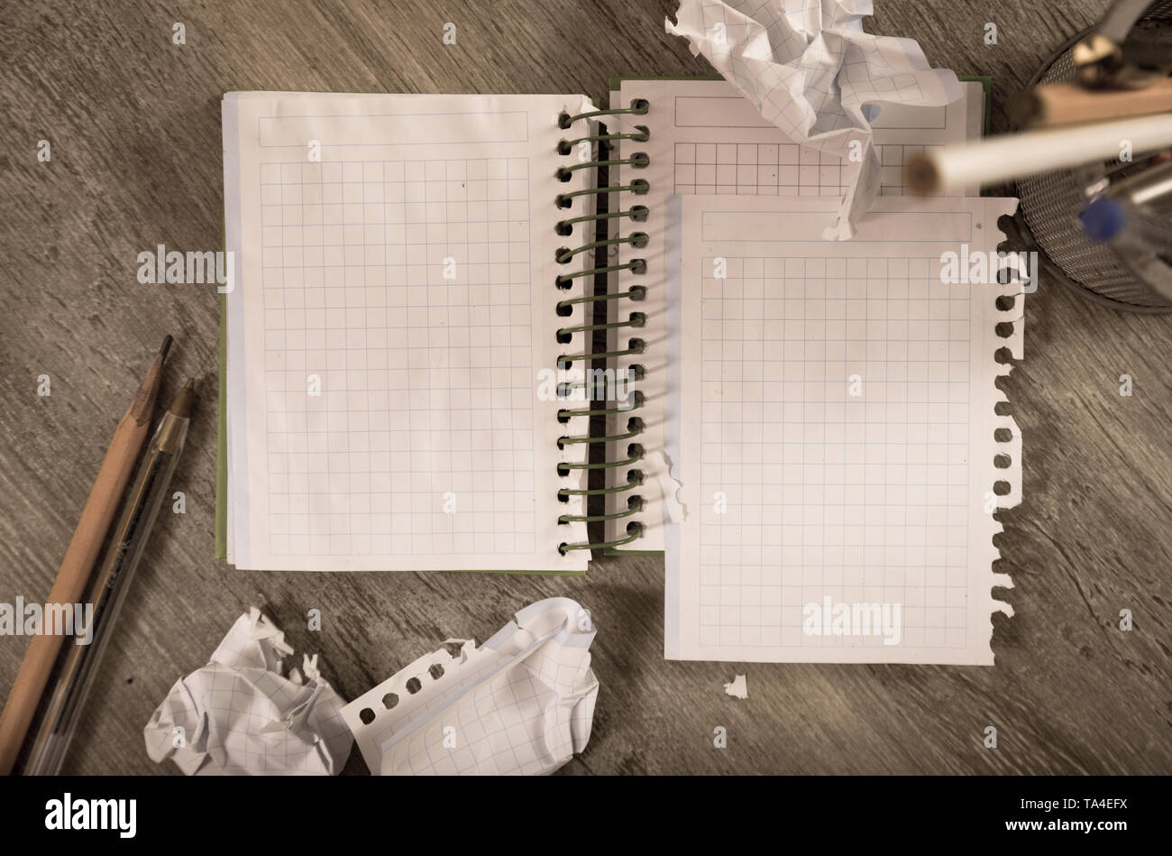 Empty crumpled pages and notebook lying on wooden surface Stock Photo ...
