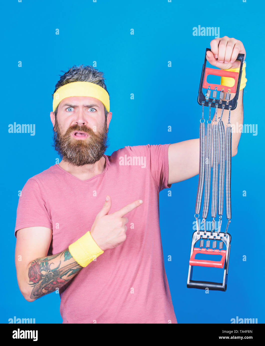 Athlete workout with expander. Sportsman training stretching expander ...