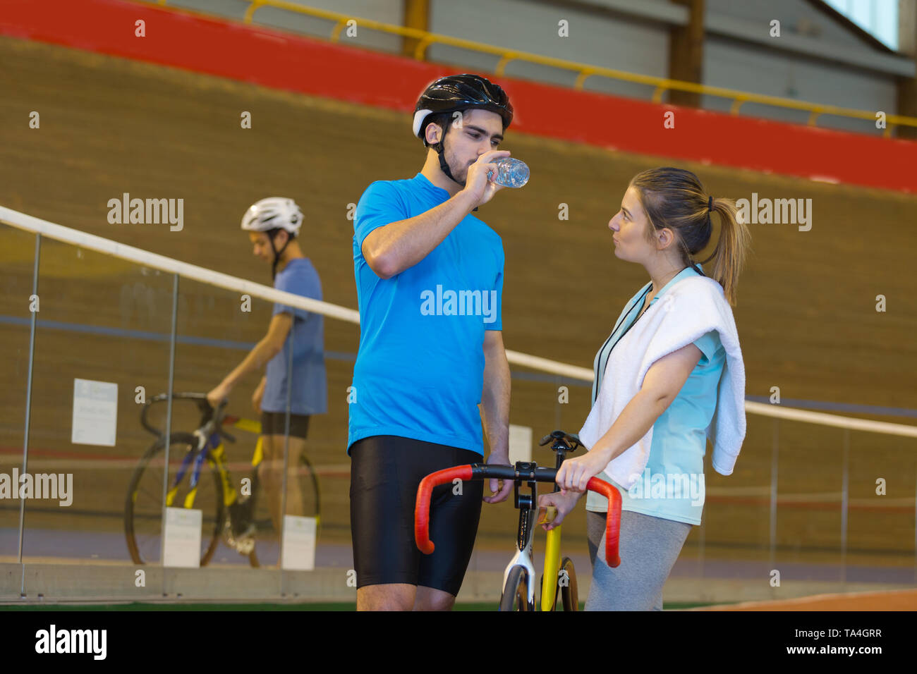female coach speaking with cyclist on velodrome track Stock Photo - Alamy