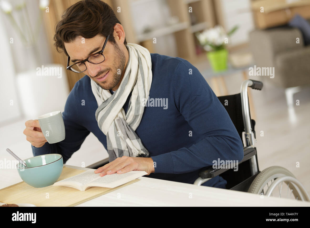 disabled man reading at home Stock Photo - Alamy