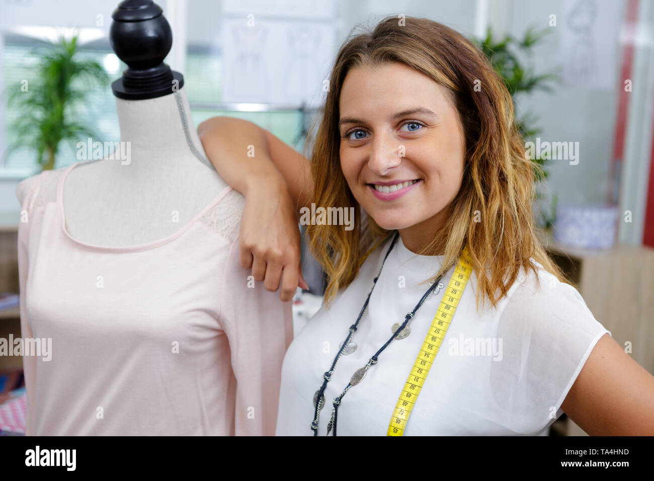 female dressmaker standing in studio with smile Stock Photo - Alamy