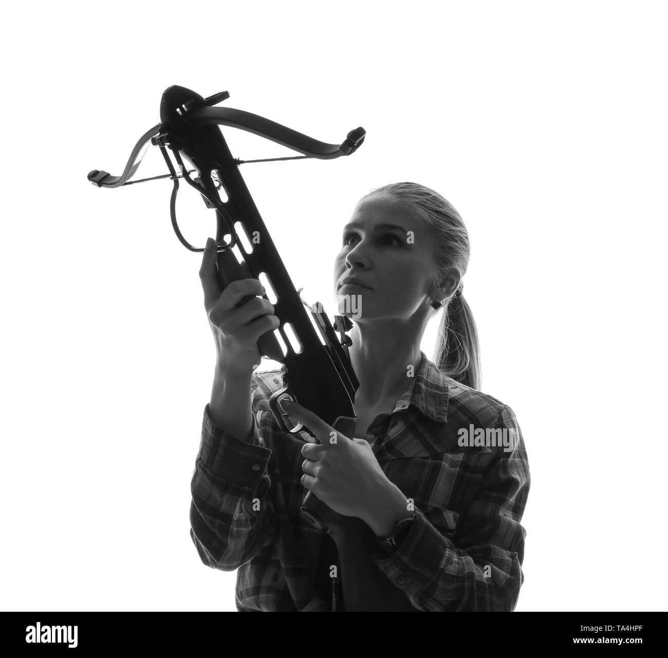Portrait of beautiful woman with crossbow on white background Stock ...