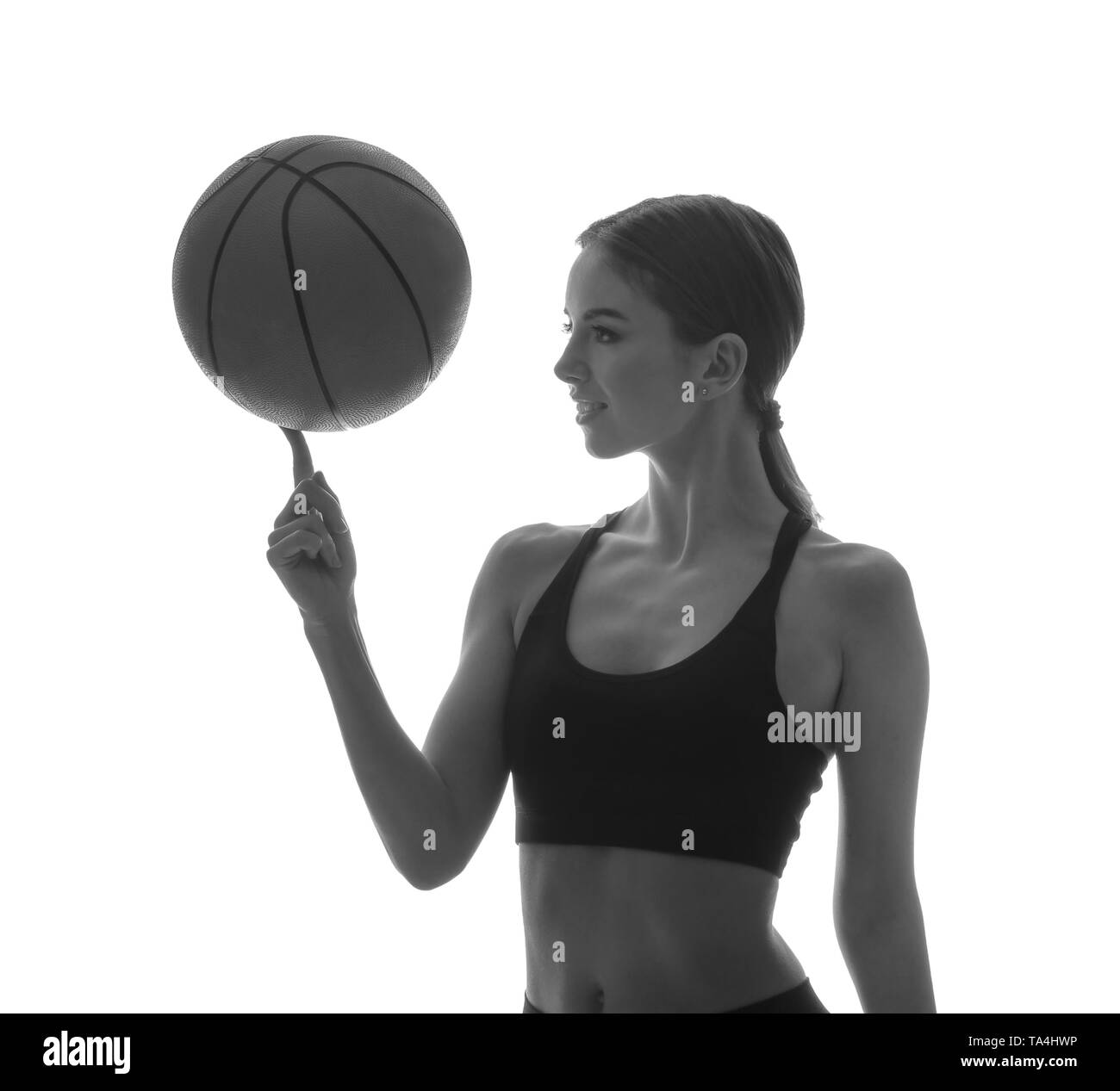 Portrait of beautiful woman playing basketball on white background ...