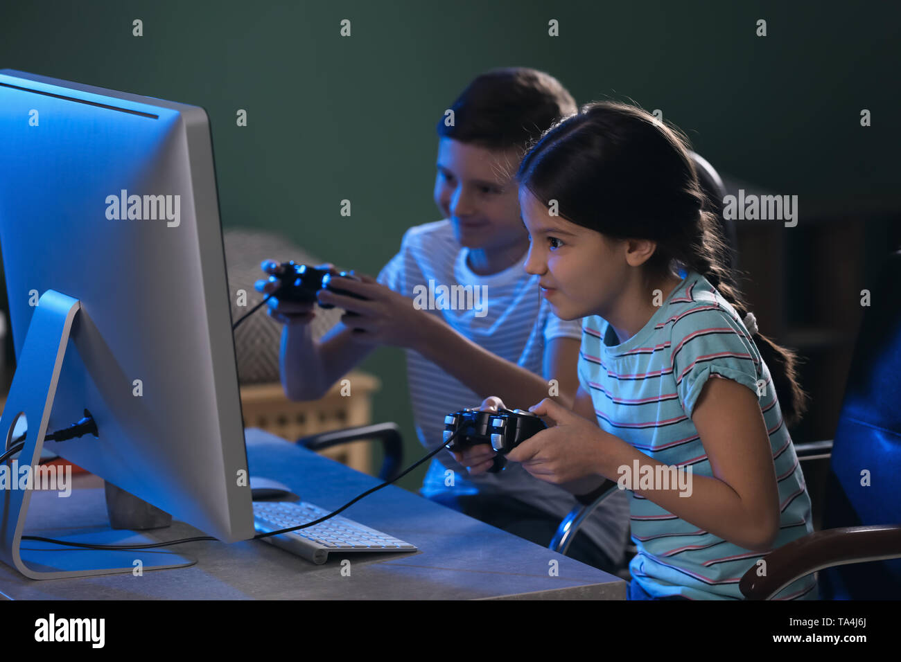 Cute little children playing computer game at home Stock Photo - Alamy