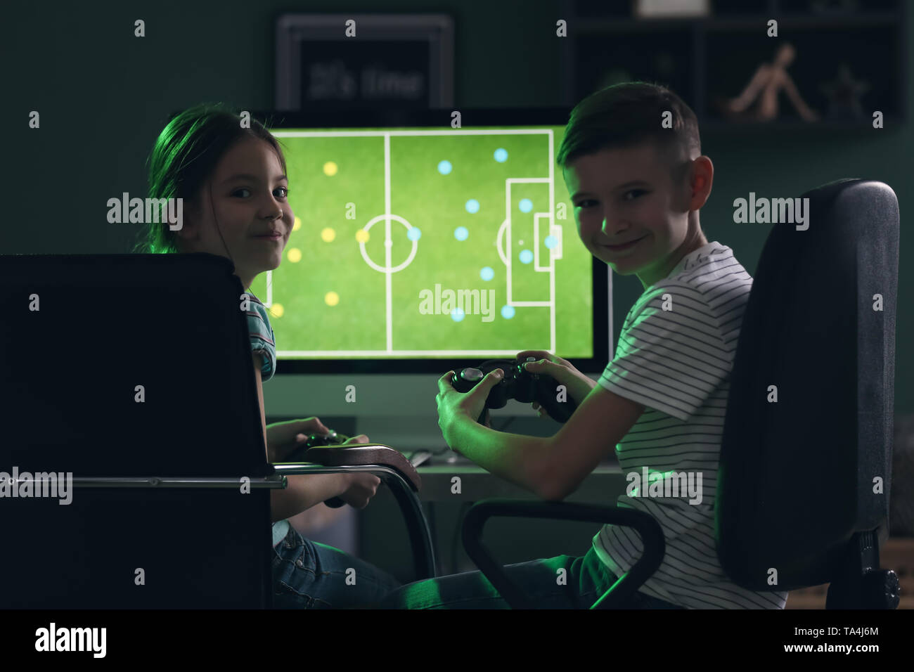 Cute little children playing computer game at home Stock Photo - Alamy