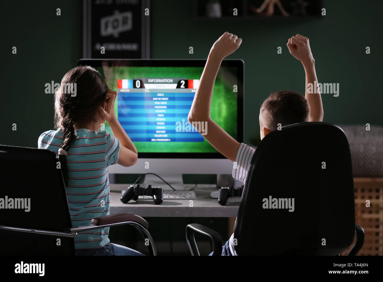 Emotional little children playing computer game at home Stock Photo - Alamy