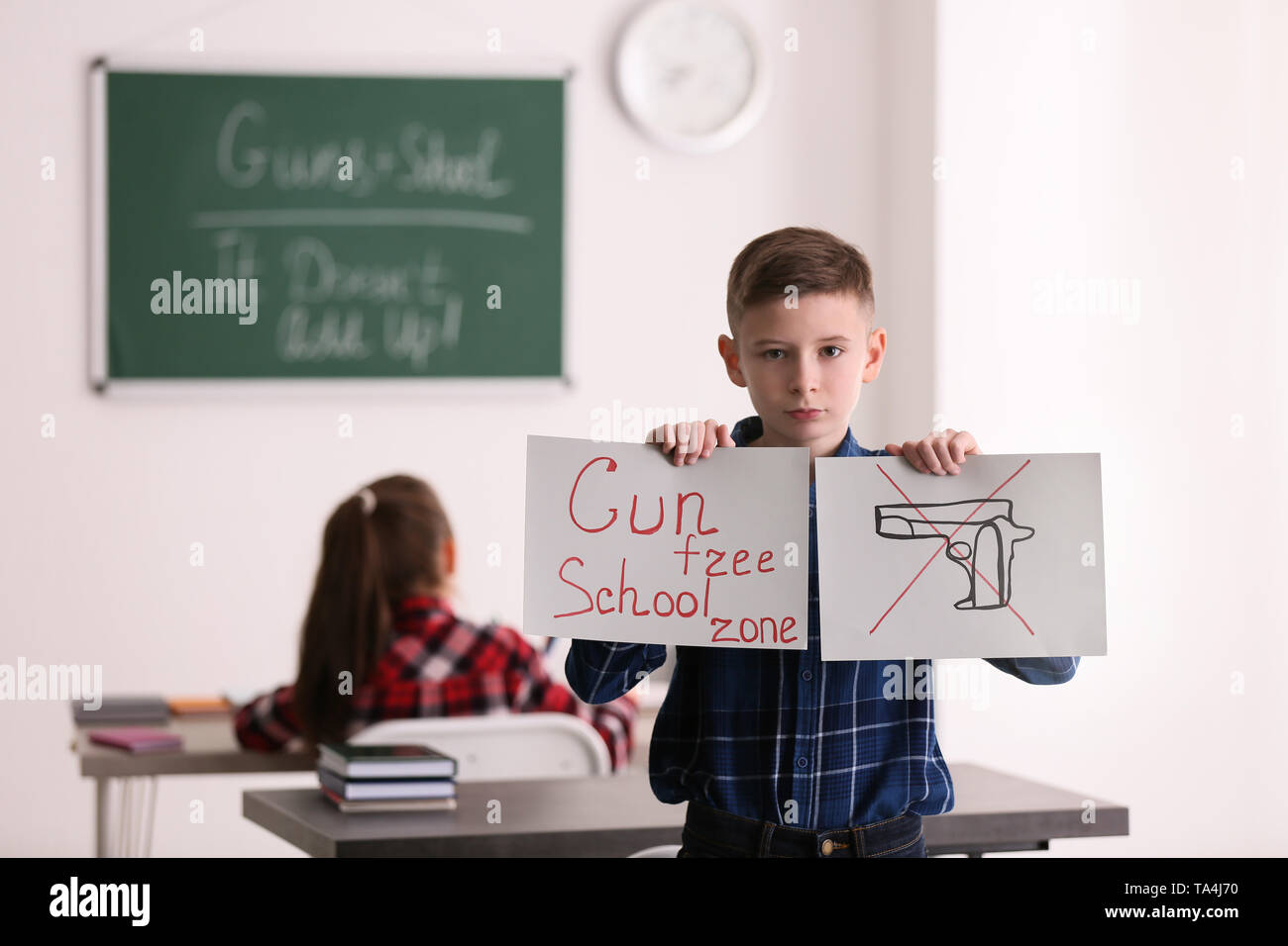 Cute little boy with agitation posters in classroom. Concept of school ...