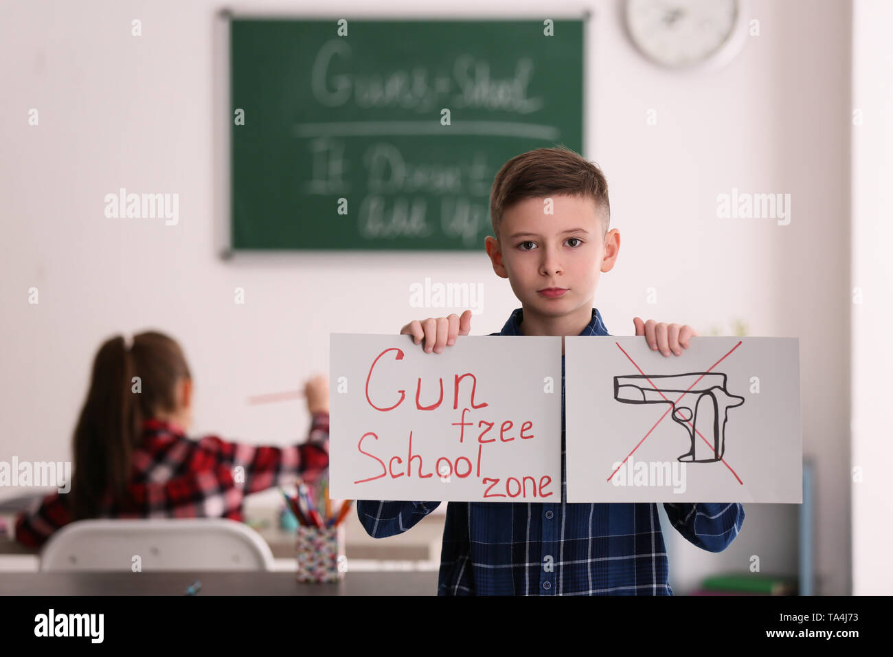 Cute little boy with agitation posters in classroom. Concept of school ...
