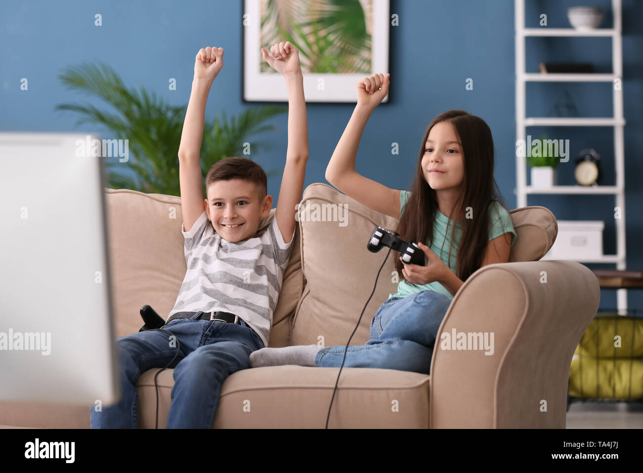 Cute little children playing computer game at home Stock Photo - Alamy
