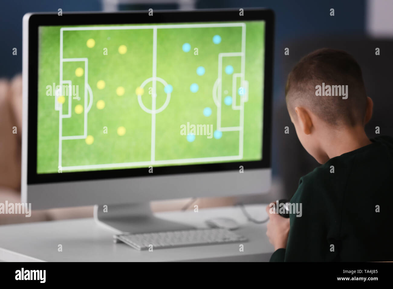 Cute little boy playing computer game at home Stock Photo - Alamy