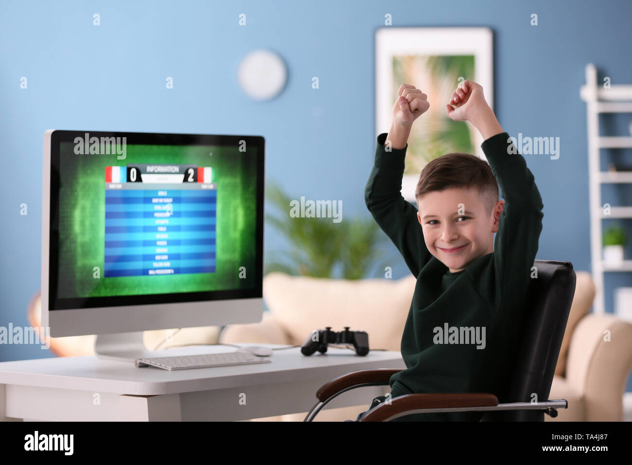 Emotional little boy playing computer game at home Stock Photo - Alamy