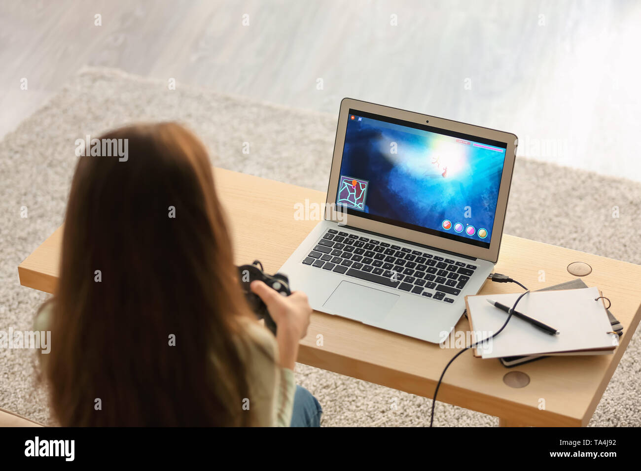 Cute little girl playing computer game at home Stock Photo - Alamy