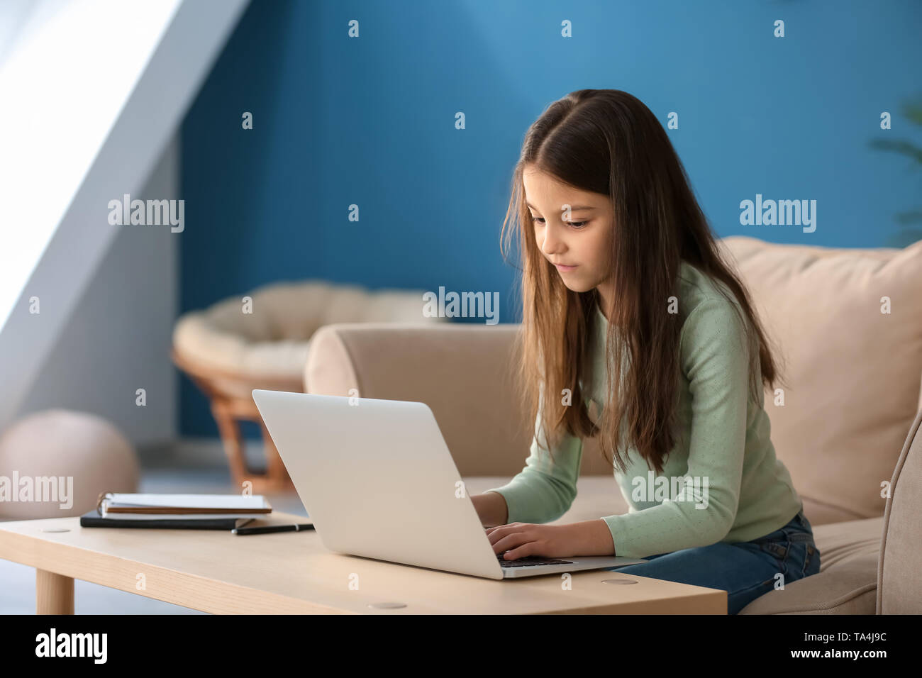 Cute little girl playing computer game at home Stock Photo - Alamy