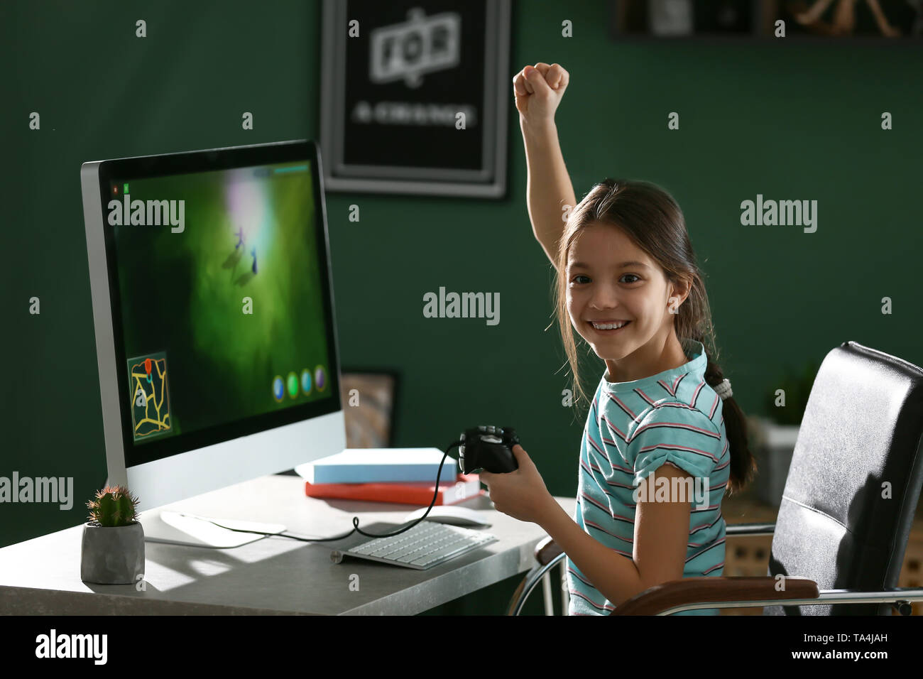 Emotional little girl playing computer game at home Stock Photo - Alamy
