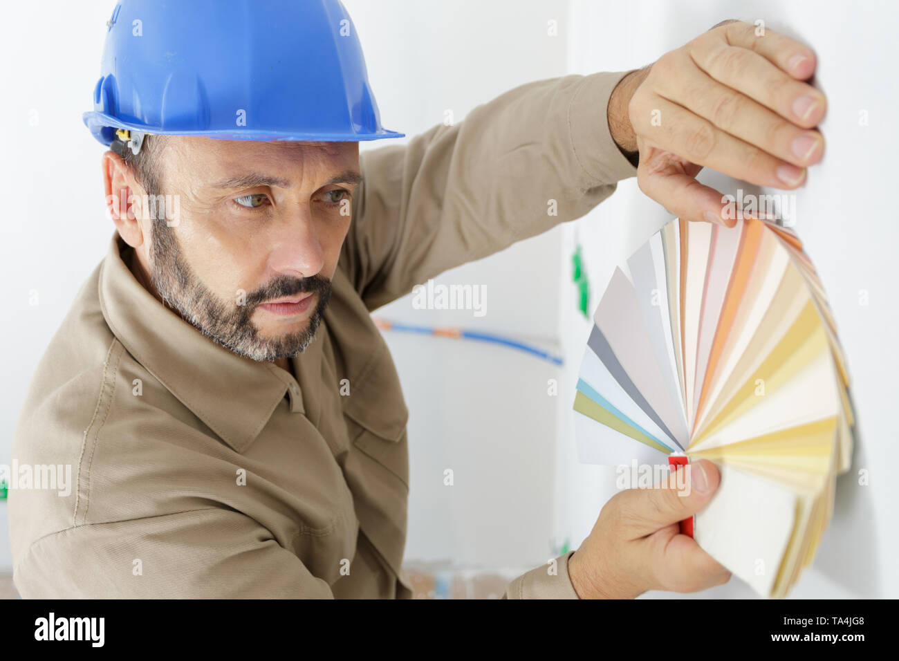 man picking a color for her house walls Stock Photo - Alamy