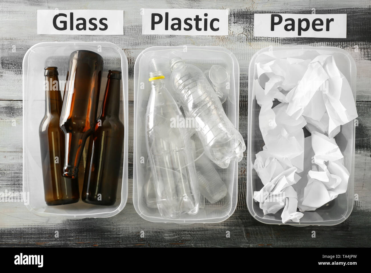 Different sorted trash on wooden background. Recycle concept Stock ...