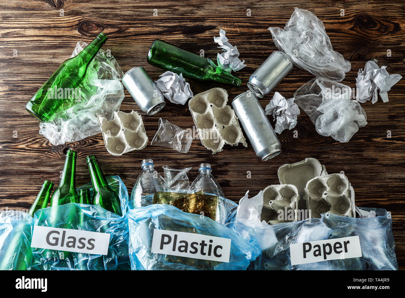 Different sorted trash on wooden background. Recycle concept Stock ...