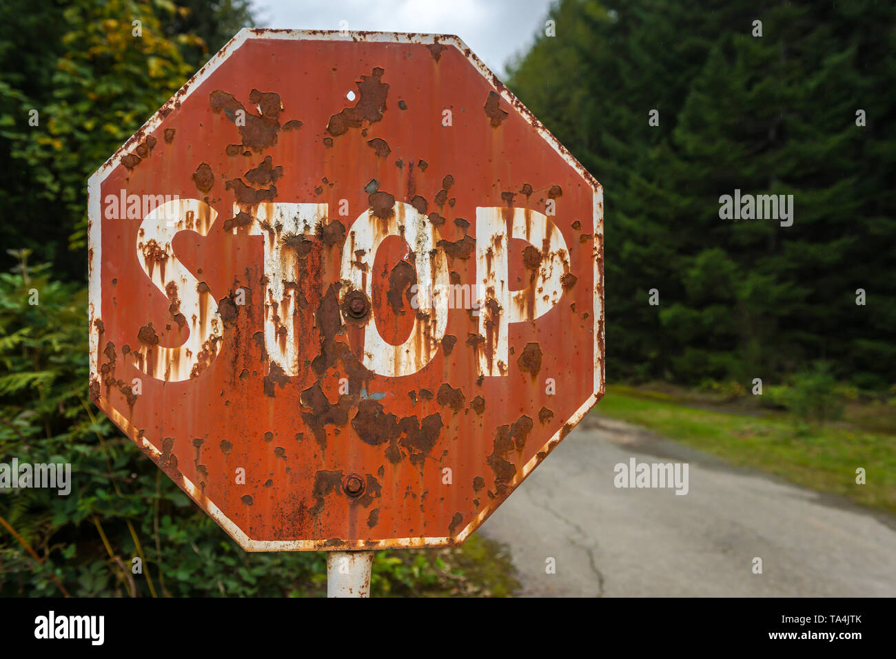 A rusty worn stop sign on a rural community road Stock Photo - Alamy
