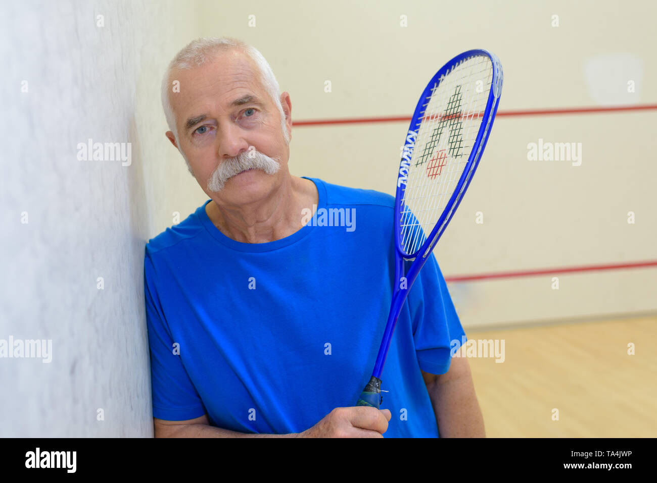 senior tennis player with racket Stock Photo - Alamy