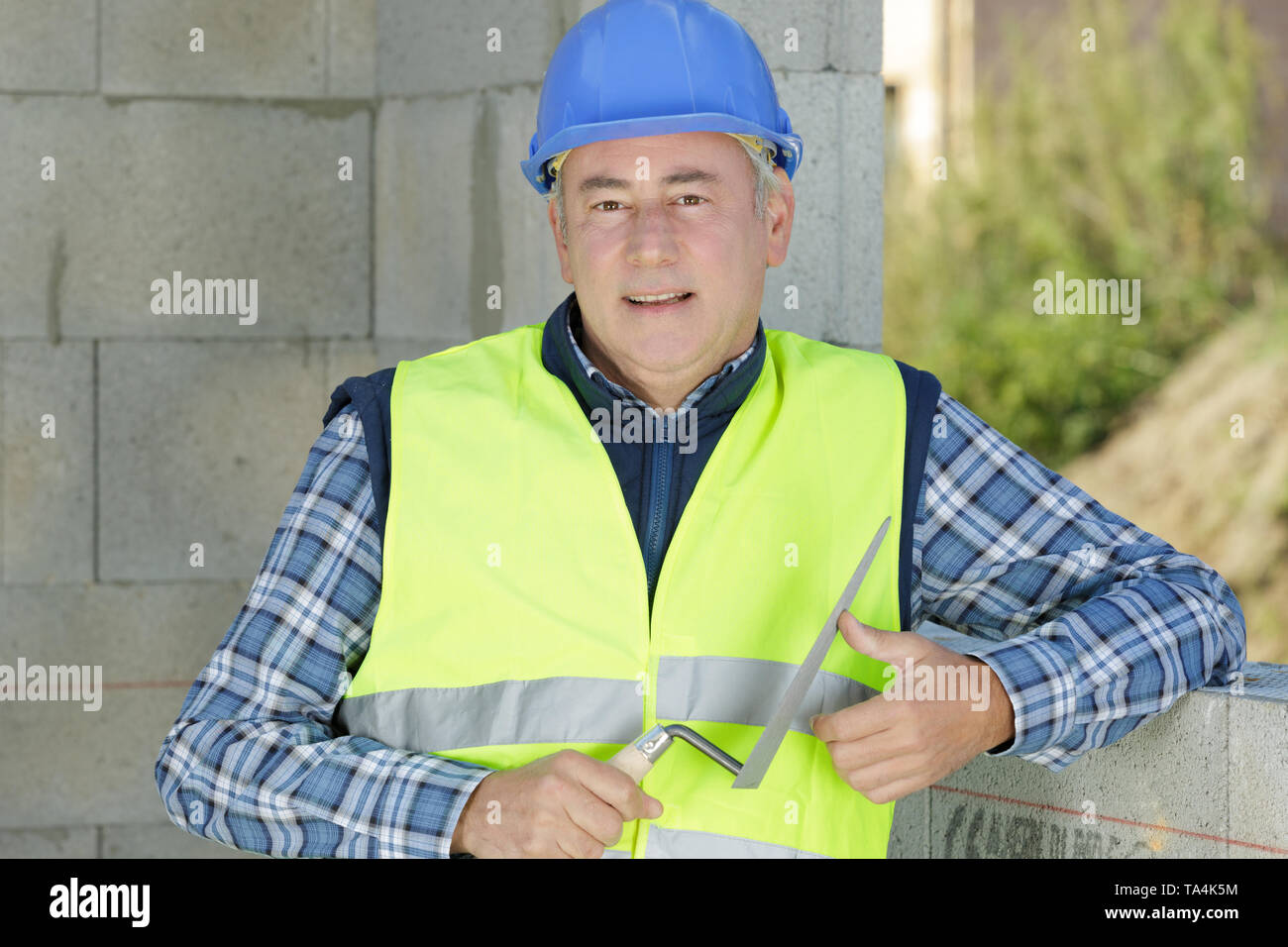 happy plasterer portrait with tools Stock Photo - Alamy