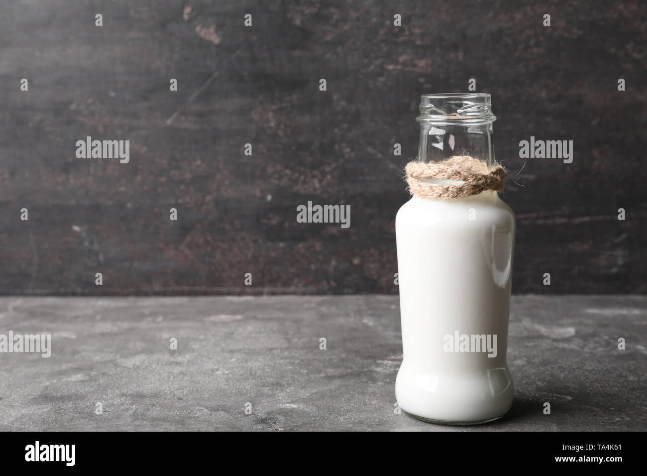 Bottle of fresh milk on grey background Stock Photo - Alamy