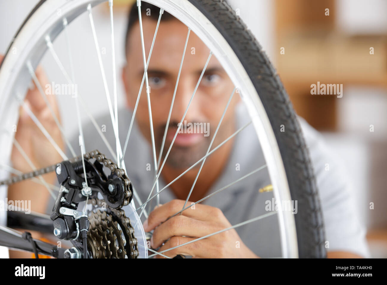 Man with bike in bikeshop hi-res stock photography and images - Alamy
