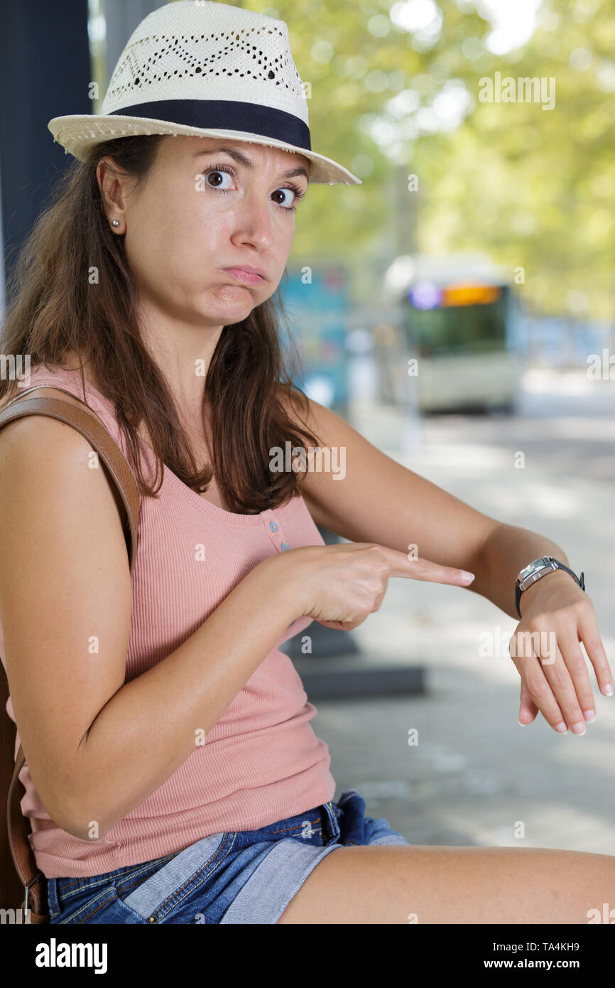 frustrated woman waiting for bus late for airport Stock Photo - Alamy